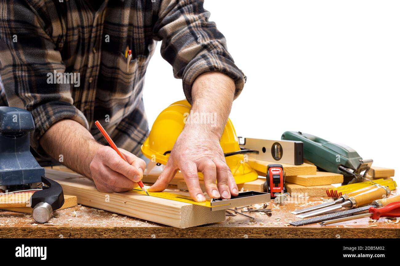 Close-up. Carpenter with pencil and carpenter's square draw the cutting ...
