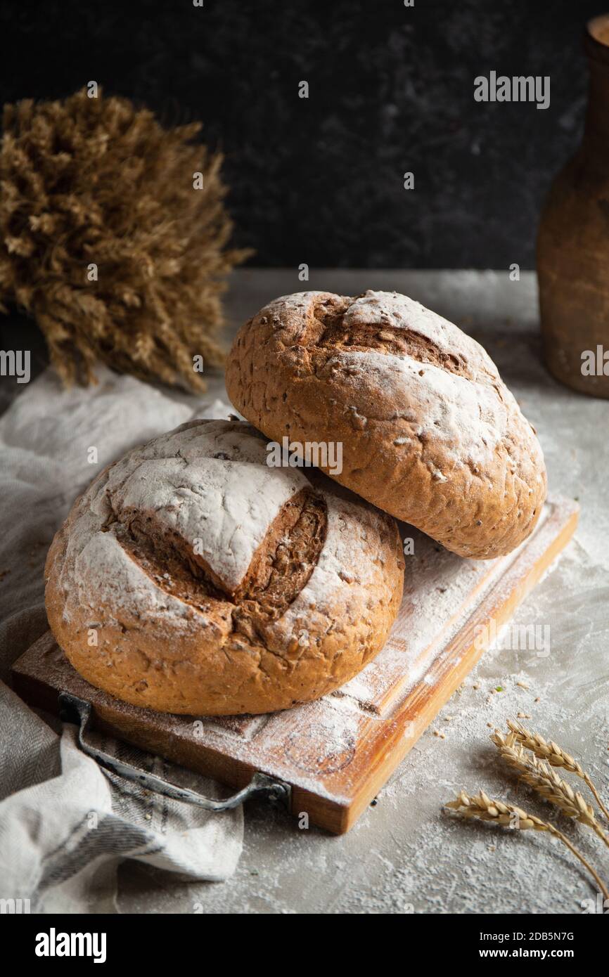 a loaf of bread lies on a wooden table Stock Photo - Alamy