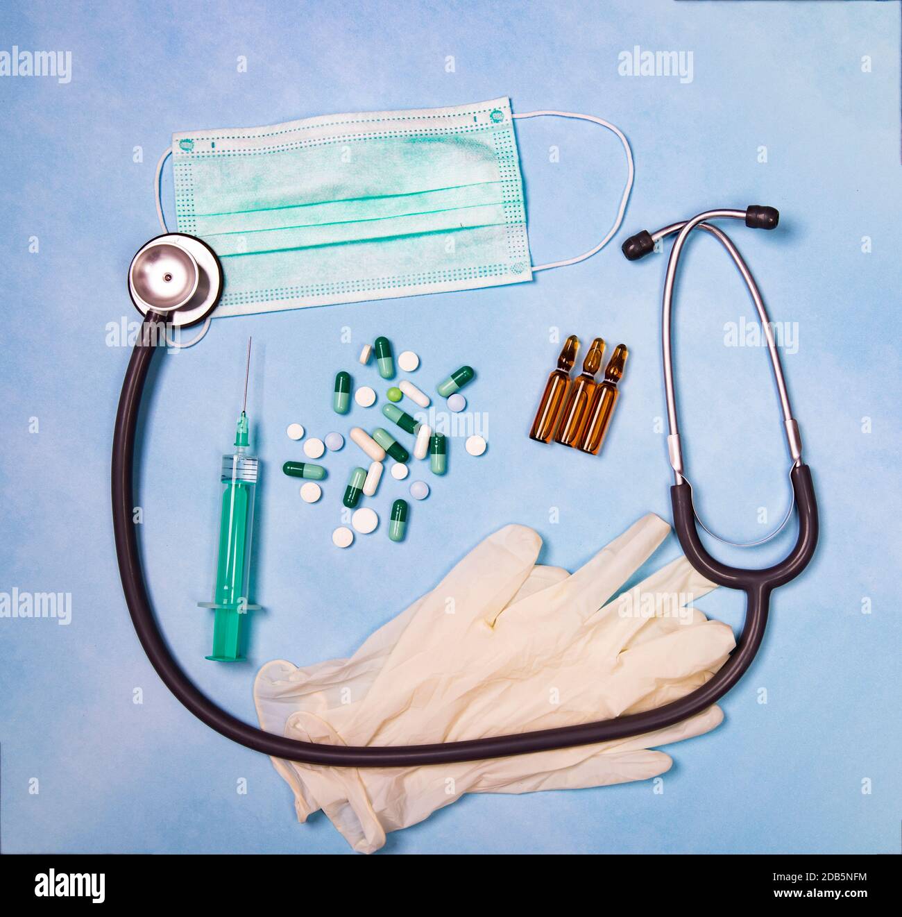 Flat-lay of medical equipment on blue background. Disease prevention ...