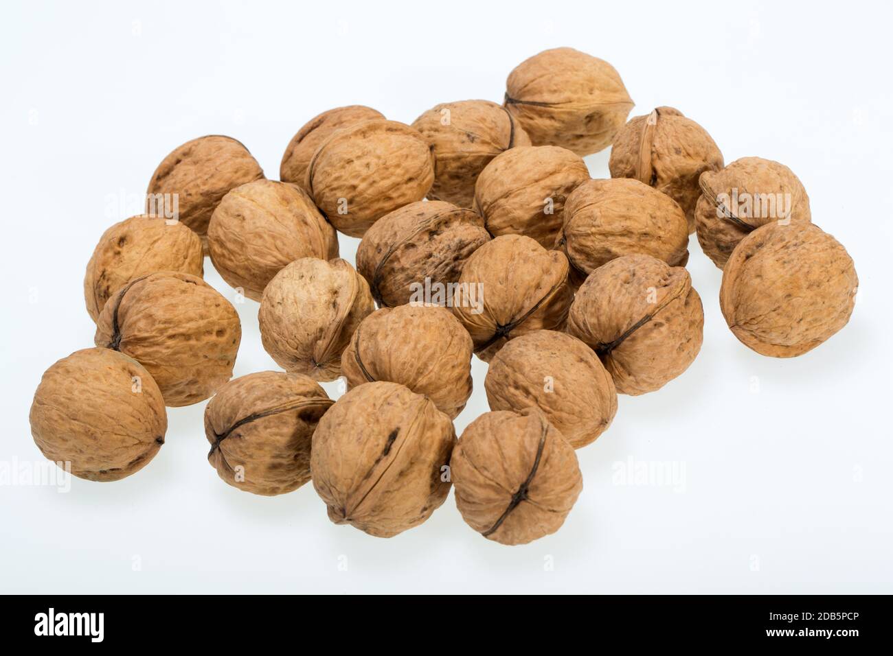 walnuts heap isolated on white background Stock Photo - Alamy