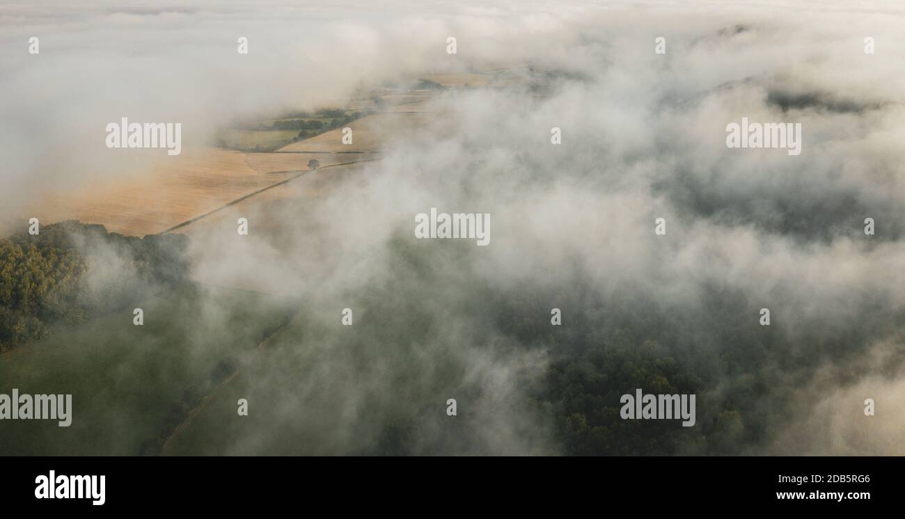 Drone shoot over breaking heavy fog over rural landscape in United ...