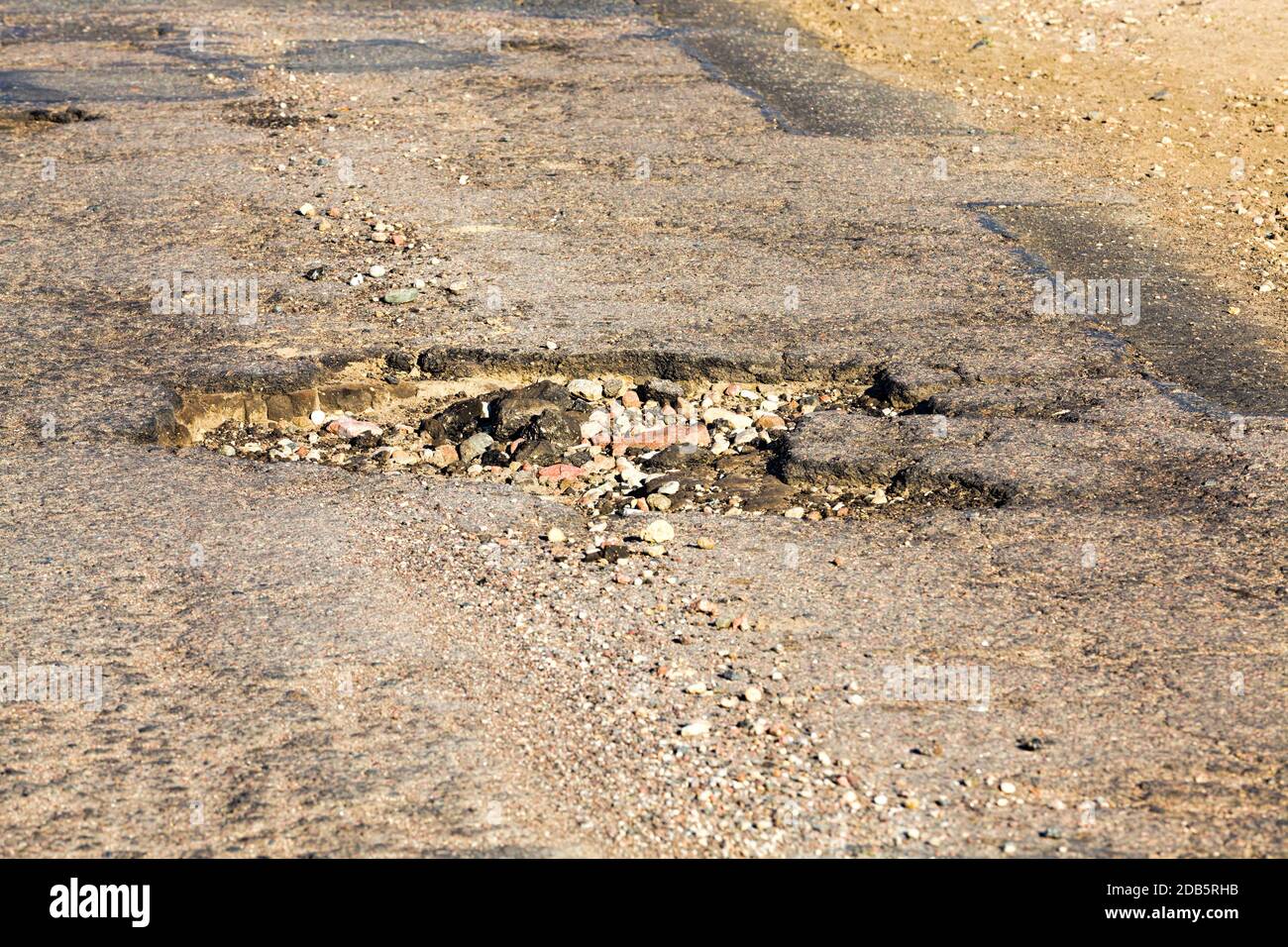 old damaged asphalt road with permanent damage and poor quality, poor ...