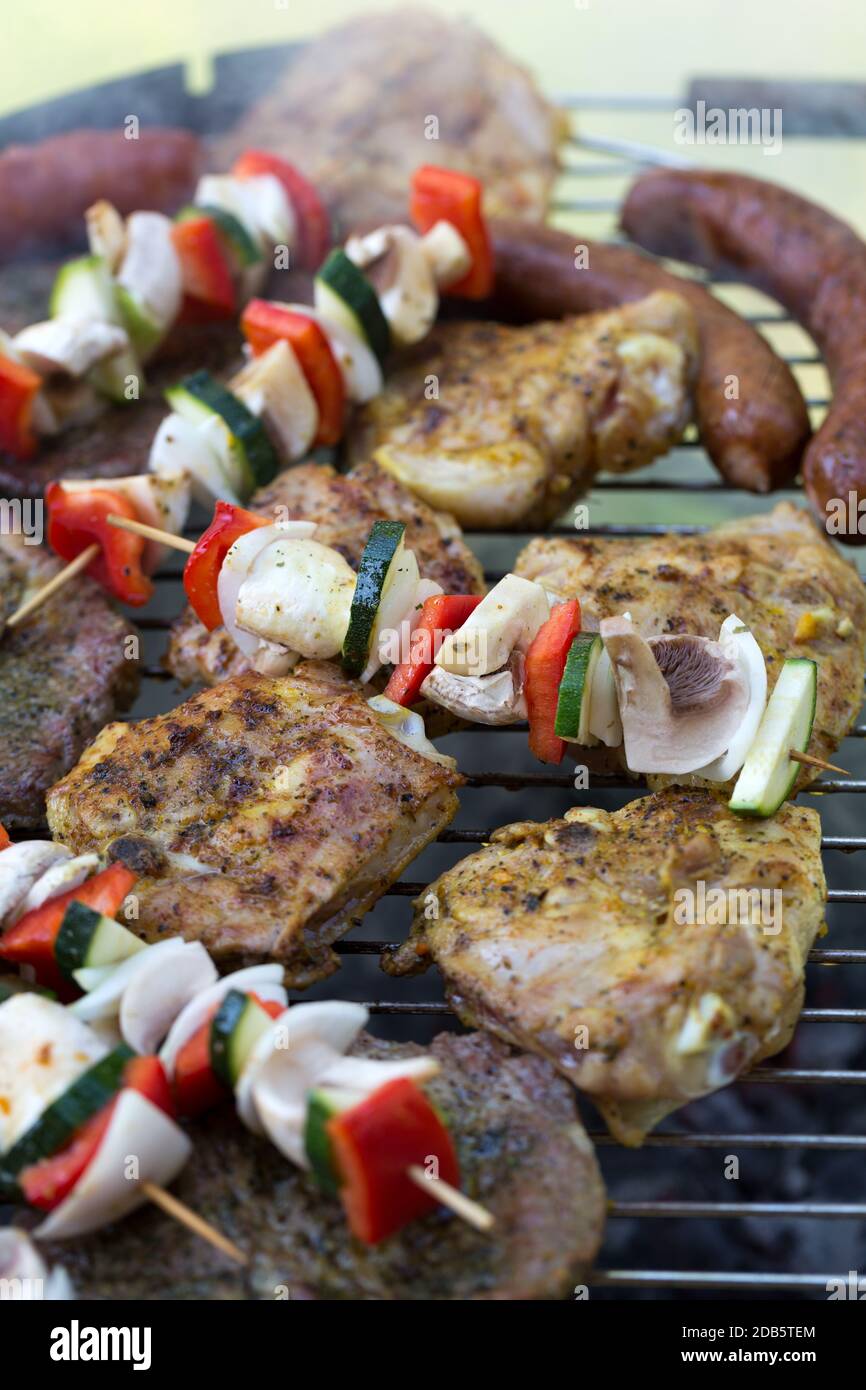 barbecue with delicious grilled meat and vegetables on grill Stock ...