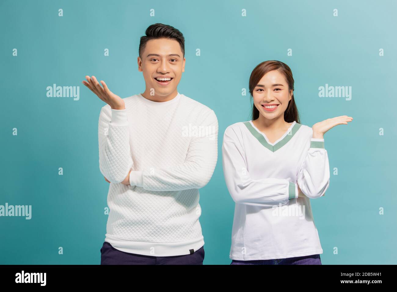 Young man presenting woman together hi-res stock photography and images ...