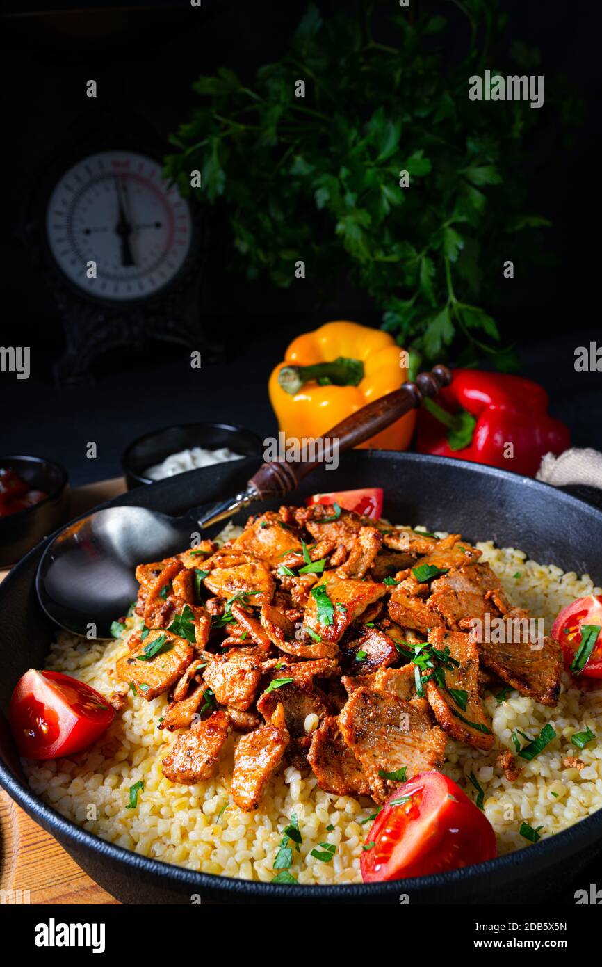 rustic bulgur pans with gratinated gyros and yoghurt Stock Photo - Alamy