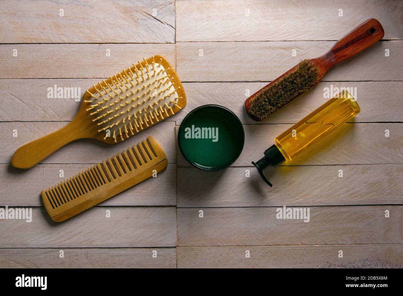 Hair gel and comb for haircut stand on a white table. Hairdressing ...