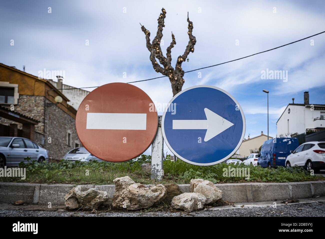 A stop and a turning sign on the road under a cloudy sky Stock Photo ...