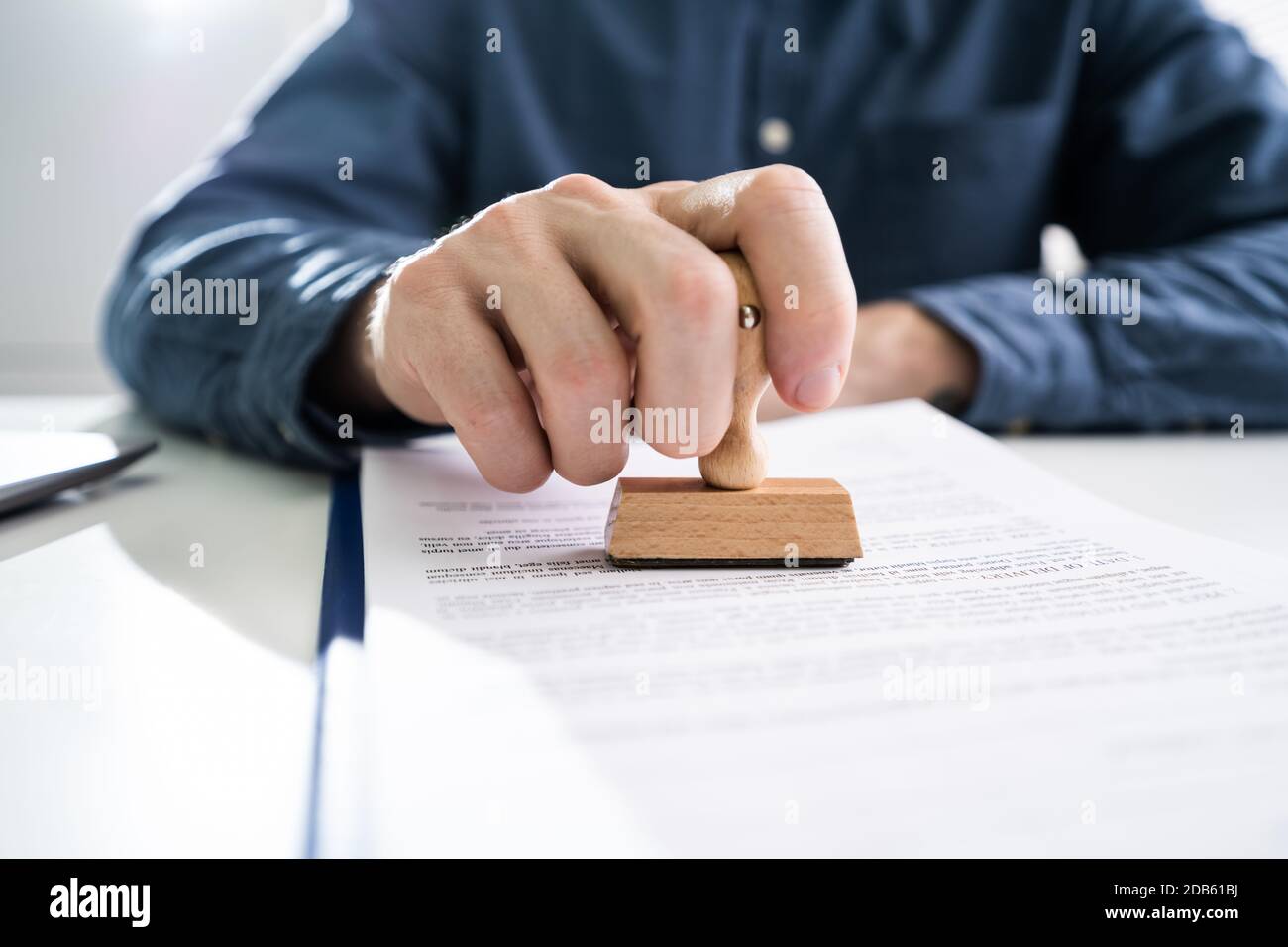 Close-up Of Person Hands Using Stamper On Document With The Text ...