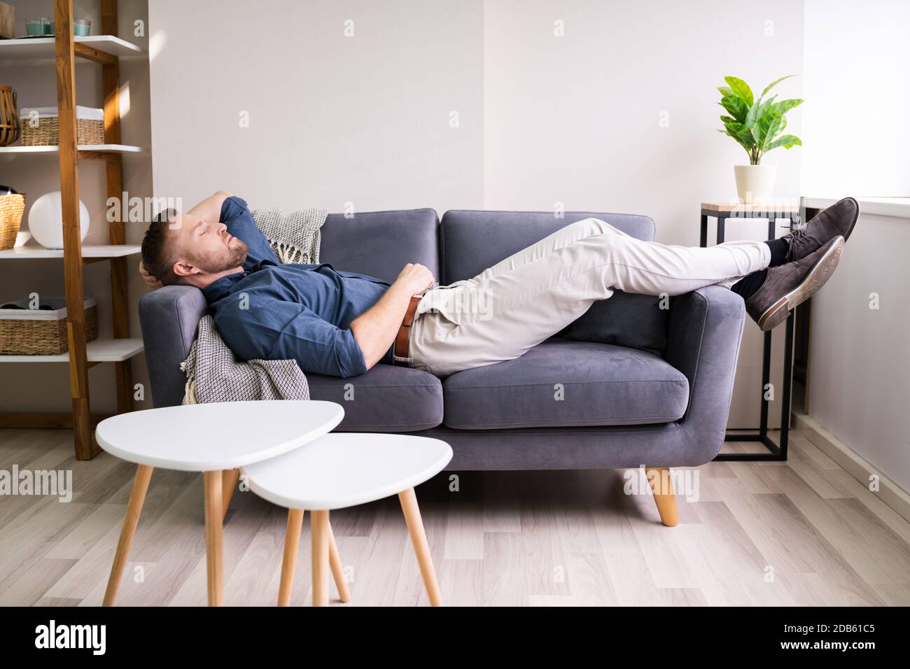 Portrait Of Tired Man Sleeping On Couch Stock Photo - Alamy