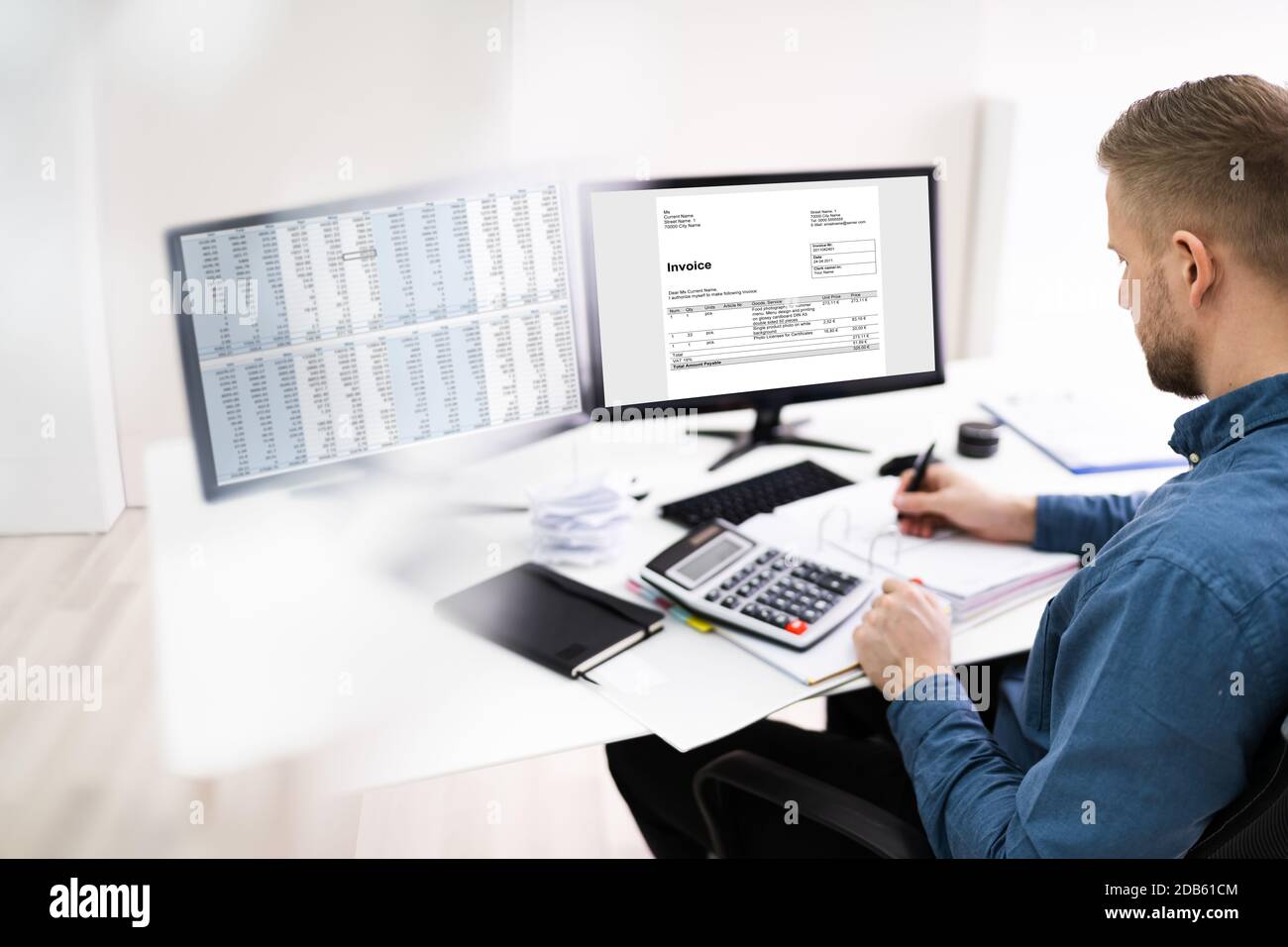 Young Businessman Calculating Bill With Computer And Laptop On Desk ...