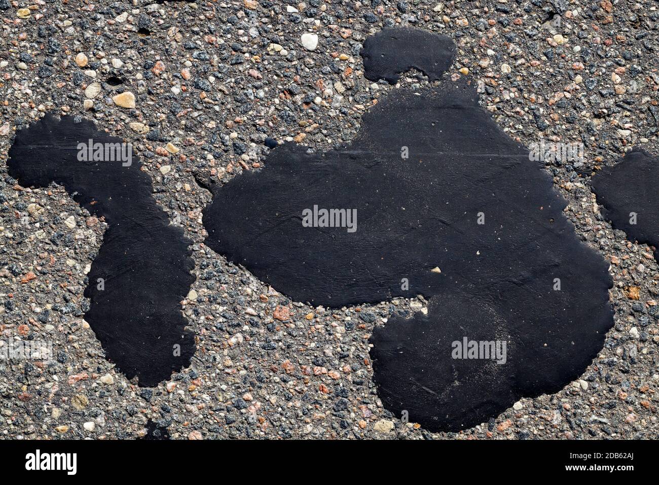 a few black spots of black fuel oil and tar and patches of pits on the ...