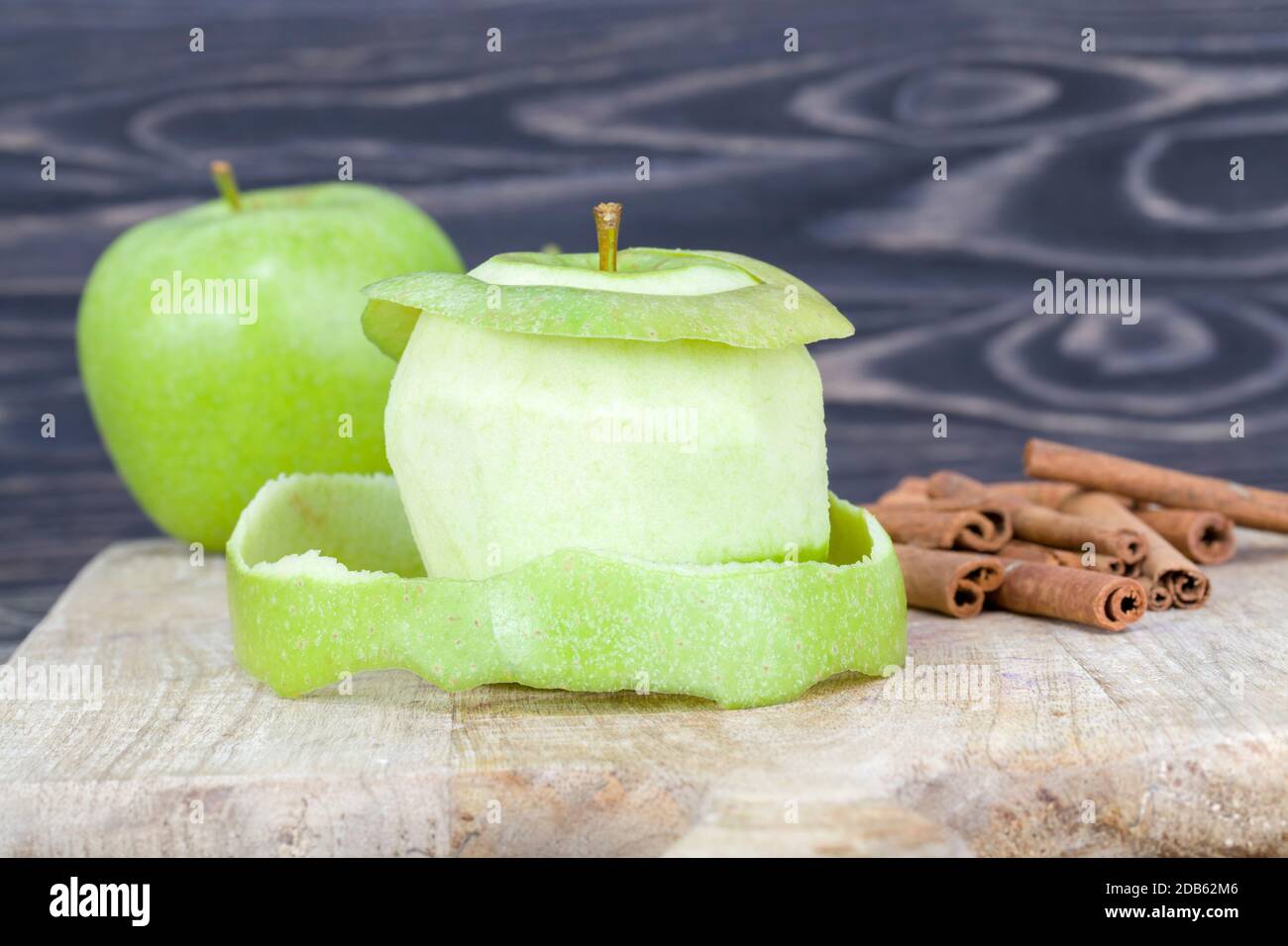 green ripe and juicy Apple peeled with a knife, lying on a cutting ...