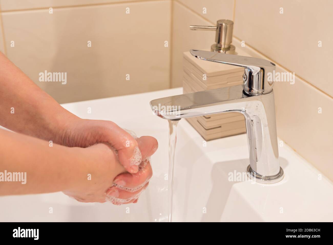 Washing of hands with soap under running water Stock Photo - Alamy