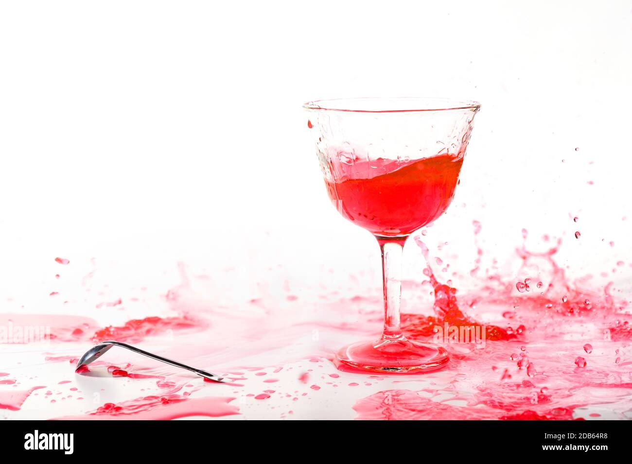 Red alcohol cocktail drink splash on white background Stock Photo - Alamy