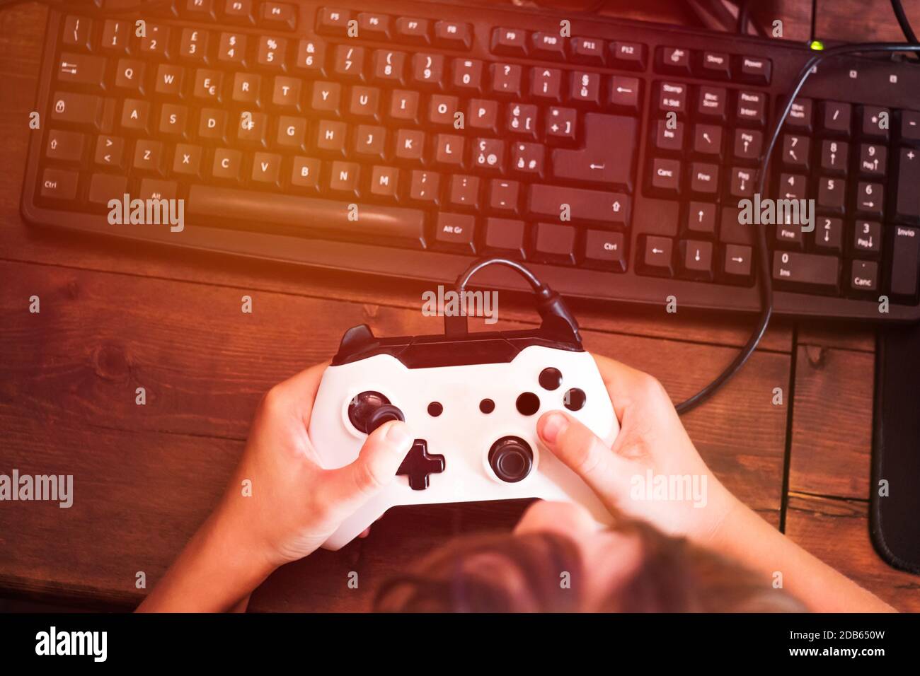 Little kid playing with joystick in front of PC Stock Photo - Alamy