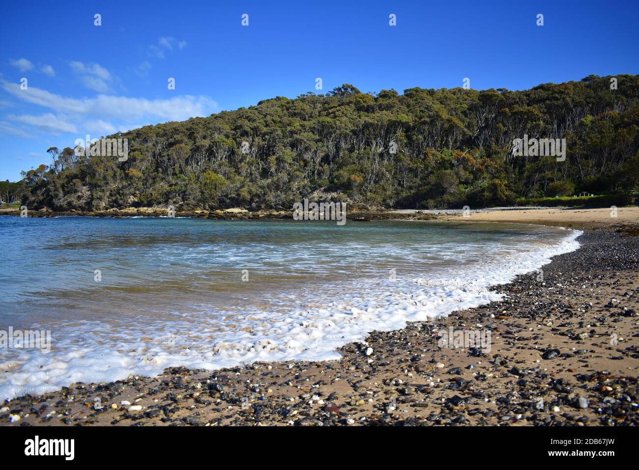 A beach with cliffs and mountains Stock Photo - Alamy