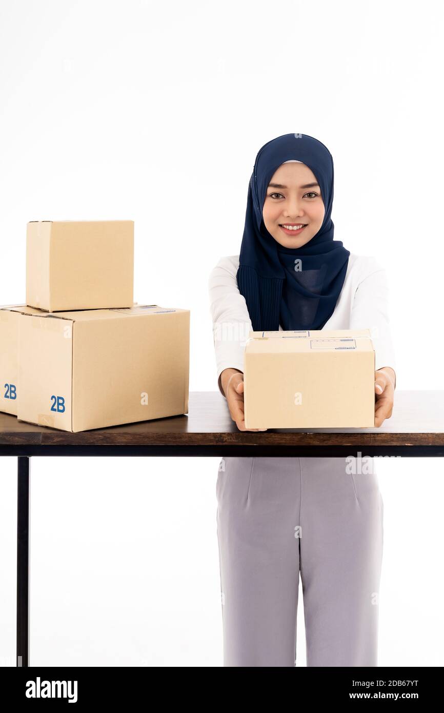 E-Commerce asian muslim women merchant work from home on wooden table ...