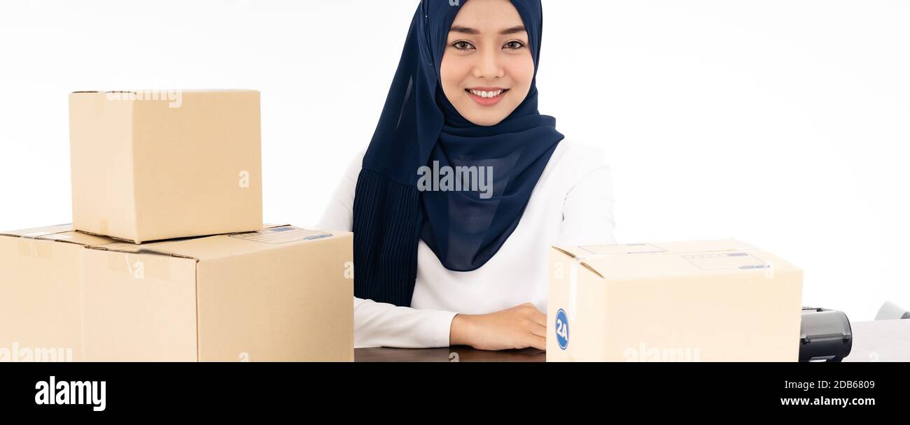 E-Commerce asian muslim women merchant work from home on wooden table ...