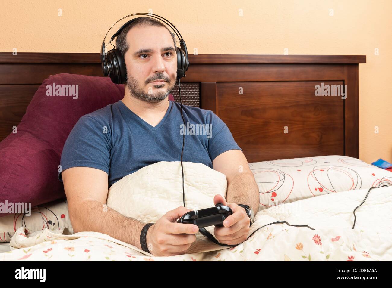 sick man with headphonelaying videogames in the bed Stock Photo - Alamy