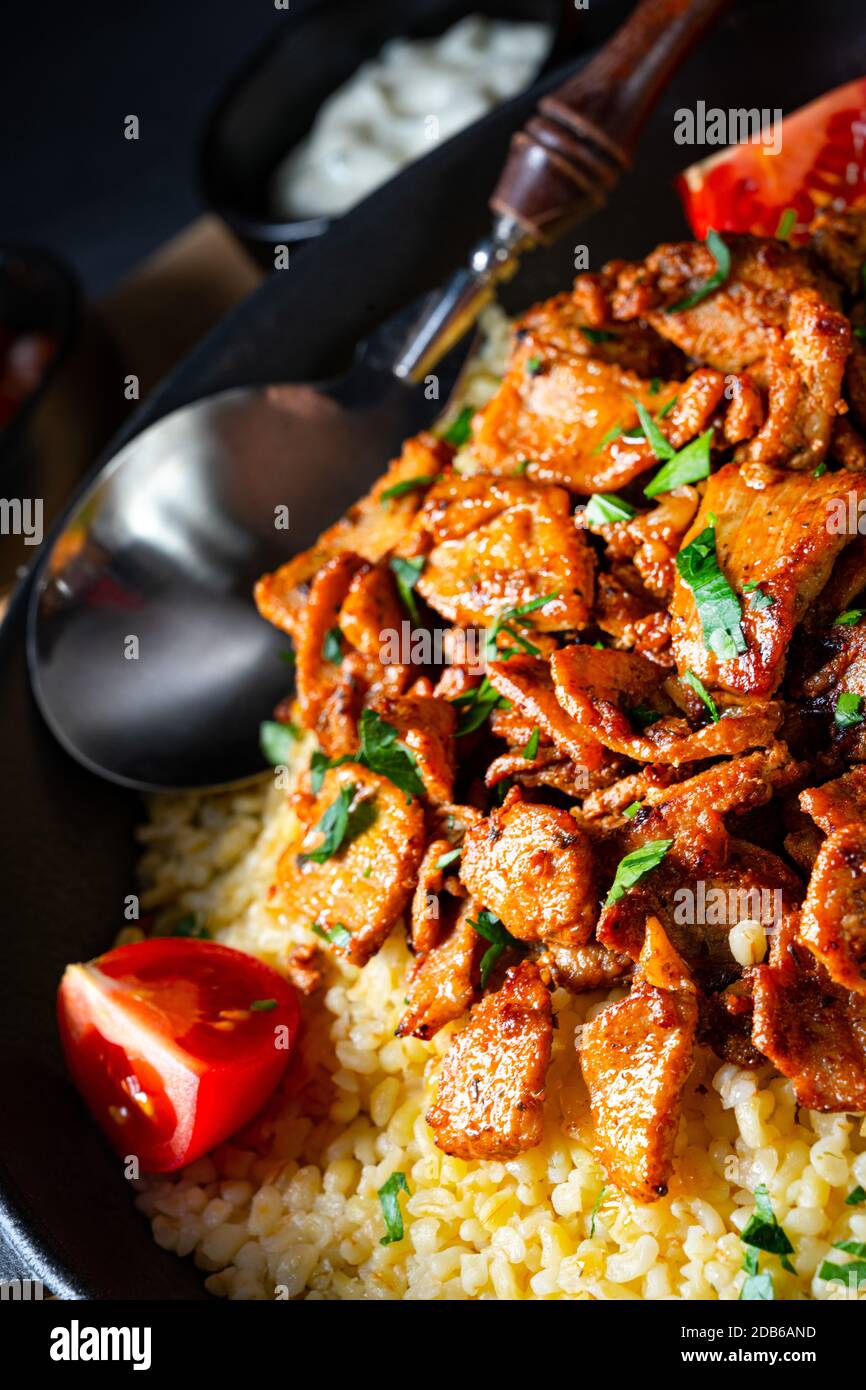 rustic bulgur pans with gratinated gyros and yoghurt Stock Photo - Alamy