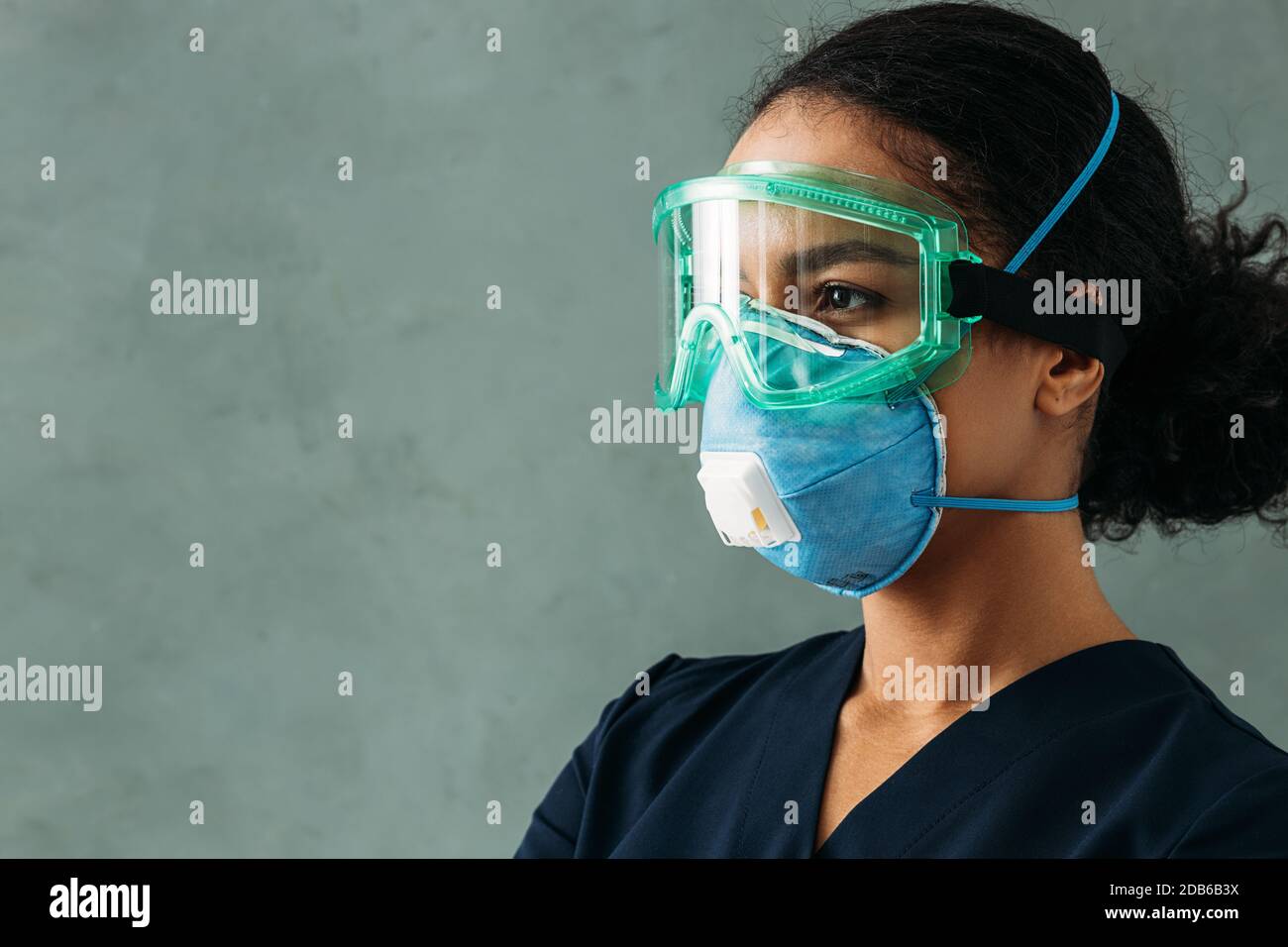 Close up portrait of female nurse wearing personal protective equipment ...
