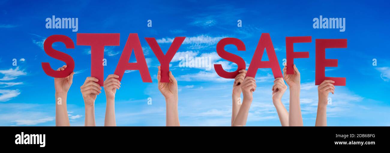 People Hands Holding Colorful English Word Stay Safe. Blue Sky As ...