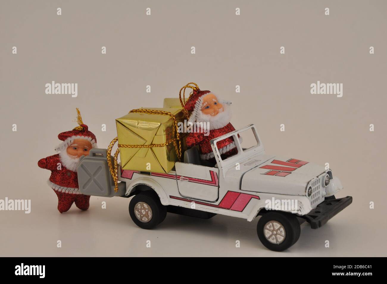 Santa Claus in his off-road, vintage car with gifts, filling his car ...