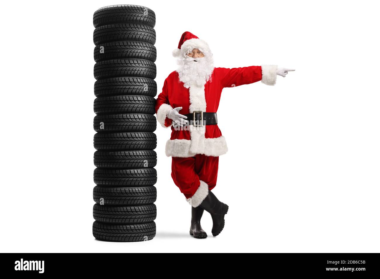 Full length portrait of santa claus leaning on a pile of tires and ...