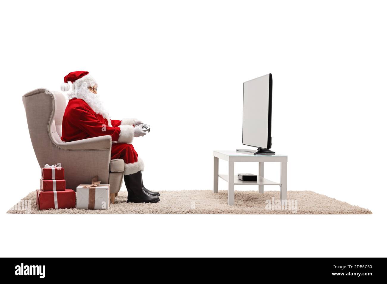 Santa claus sitting in an armchair and playing video games on tv ...
