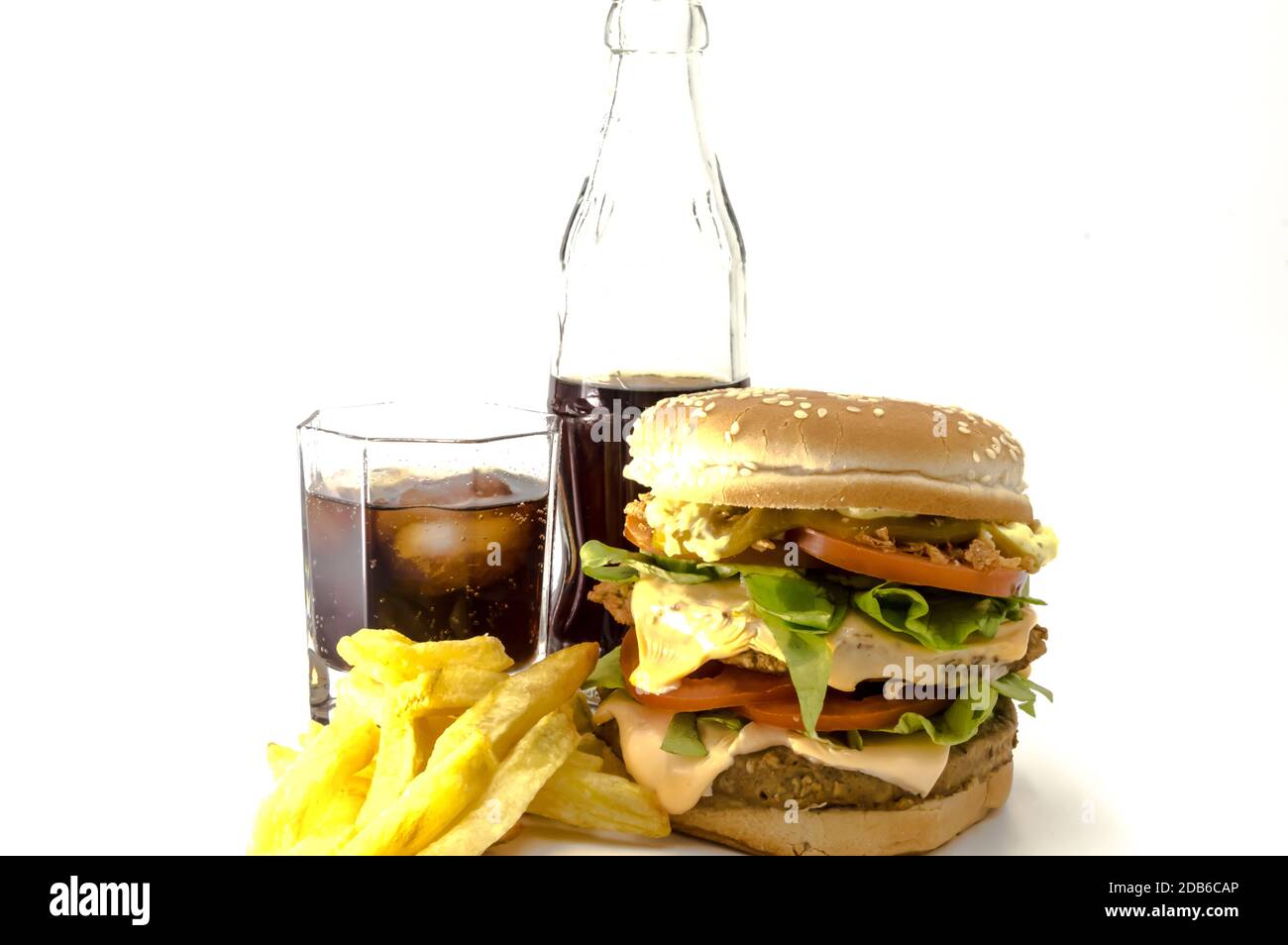 Double meat and cheese burger with fresh fries and a coke on a white ...