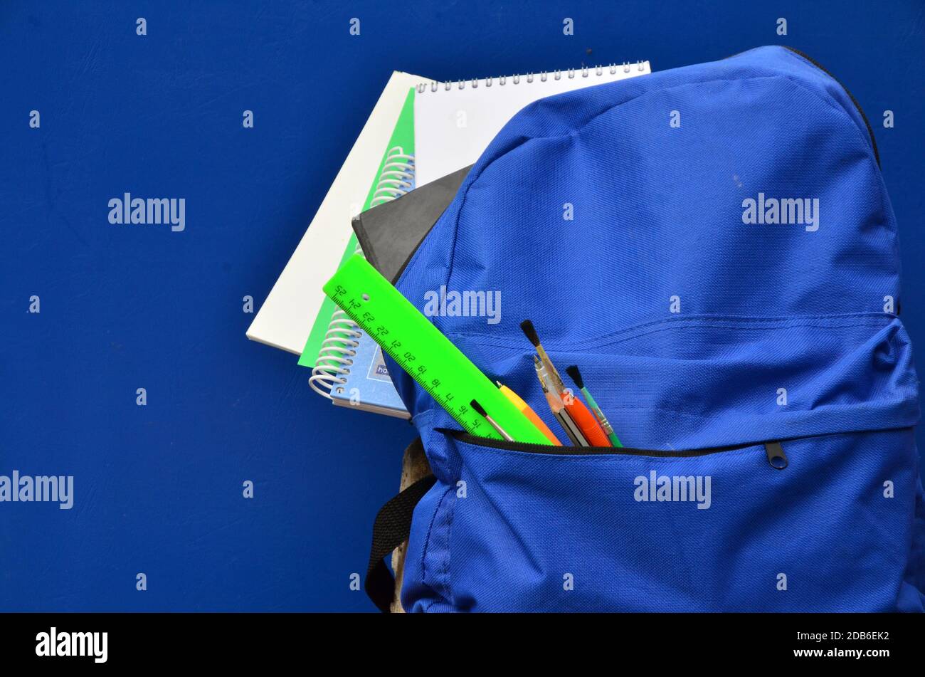 Full School backpack on wooden and nature background school supplies ...