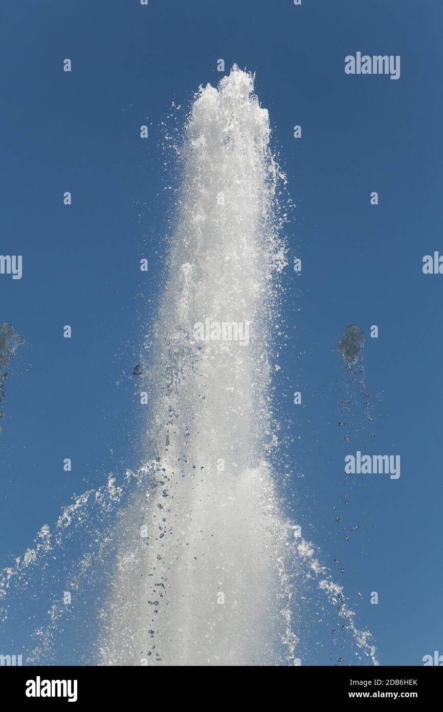Fountain water jets against clear blue sky Stock Photo - Alamy