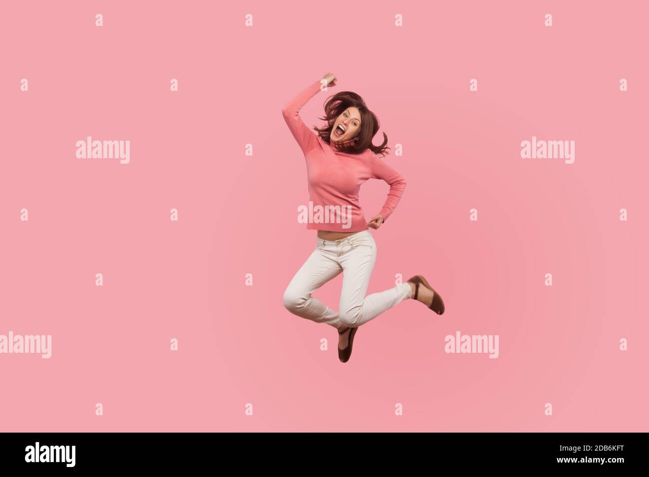 Extremely happy satisfied woman jumping high celebrating her success ...