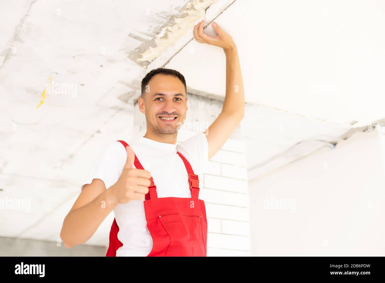 Young man fixing ceiling insulated. Renovation, construction Stock ...