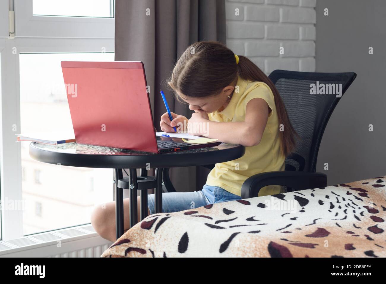 Girl does homework with distance learning services Stock Photo - Alamy