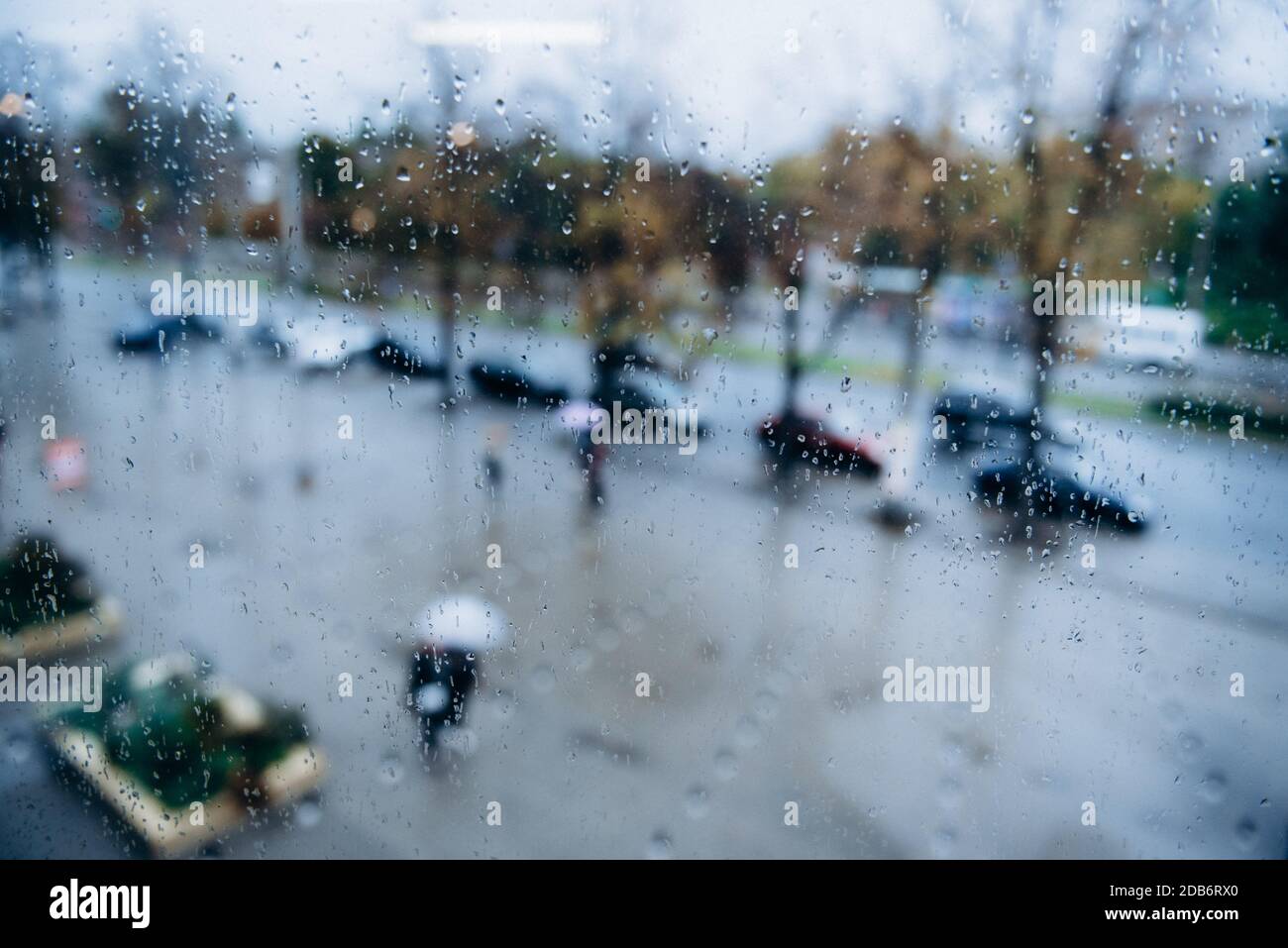 people walk in the rain on the street, view through a wet window Stock ...