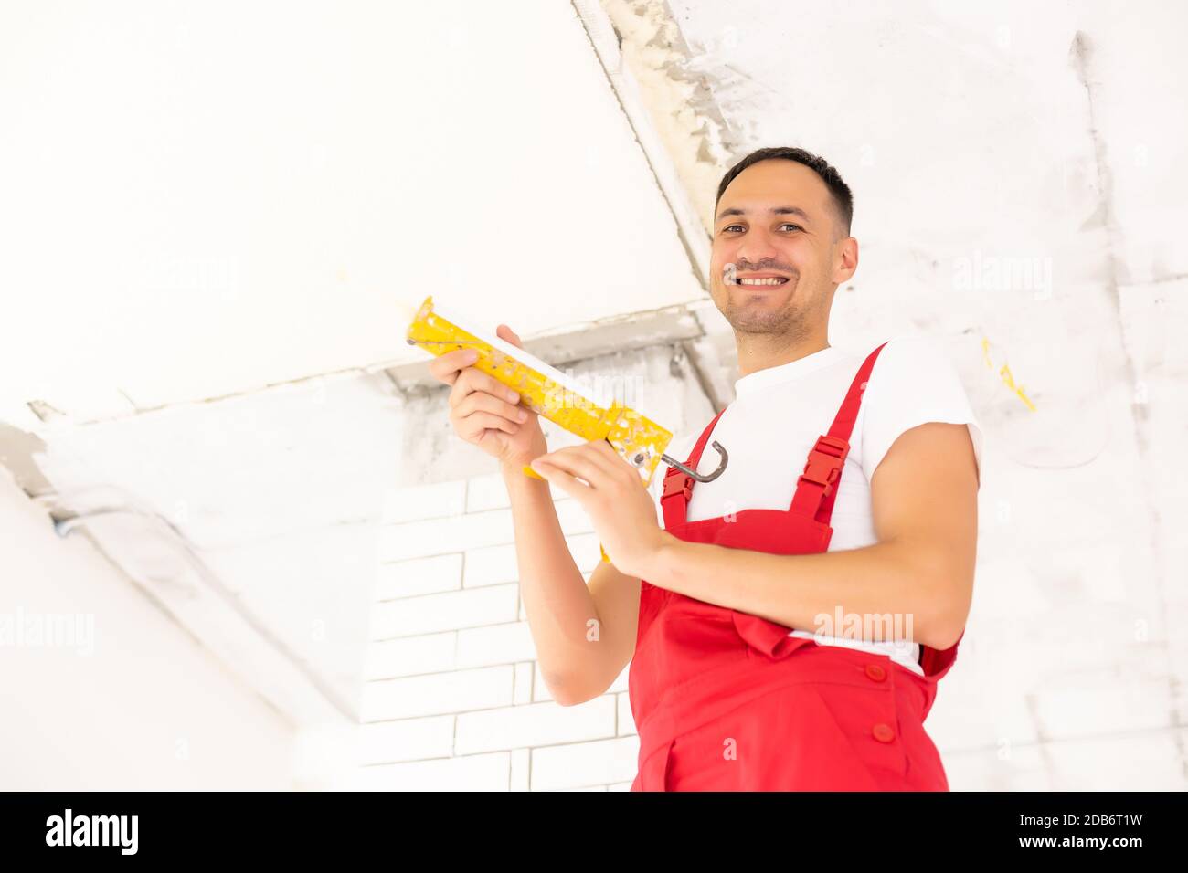 Young man fixing ceiling insulated. Renovation, construction Stock ...