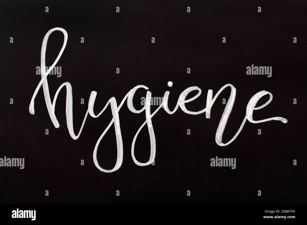 Chalk inscription HYGIENE on a black chalkboard. Handwritten lettering ...