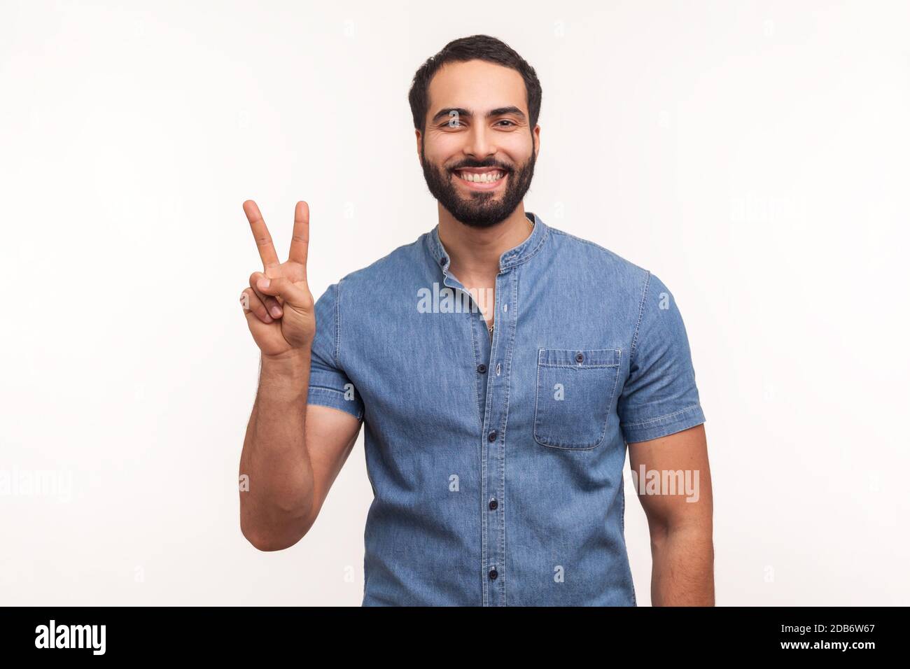 Happy satisfied man showing v sign symbol of peace with fingers ...
