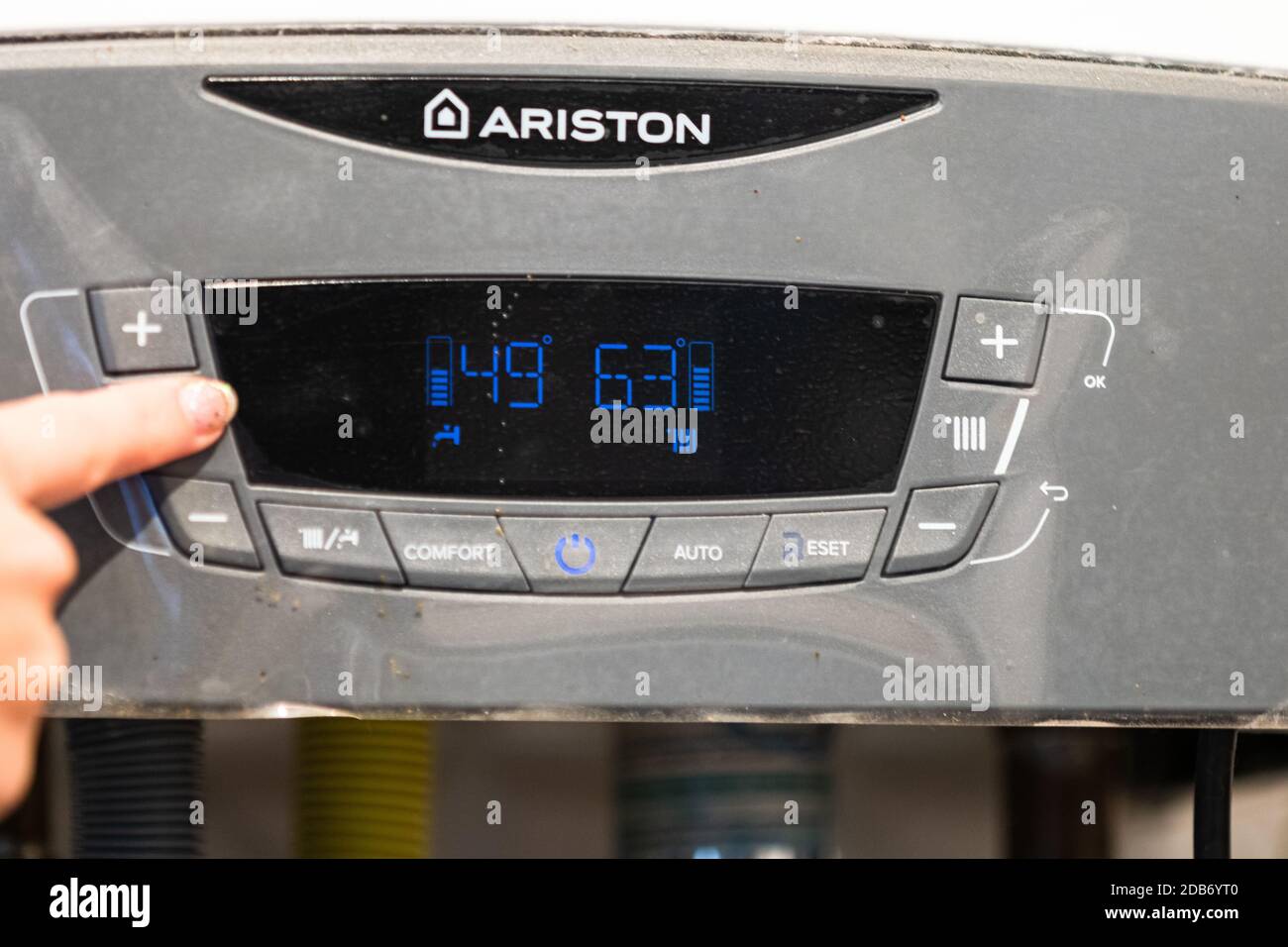 Girl hand setting temperature to heating system. Central heating ...