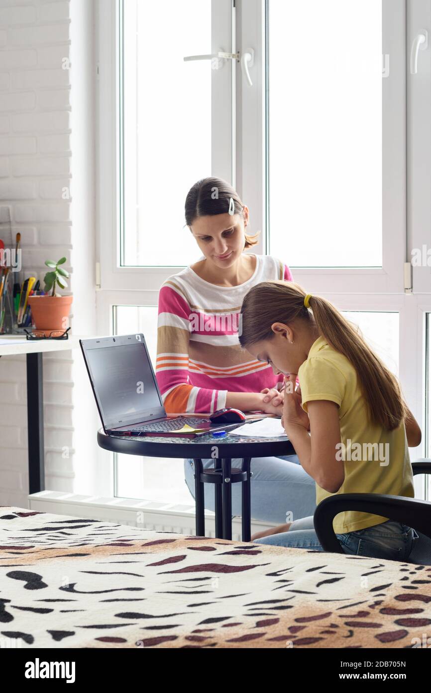 The tutor at home teaches a primary school child Stock Photo - Alamy