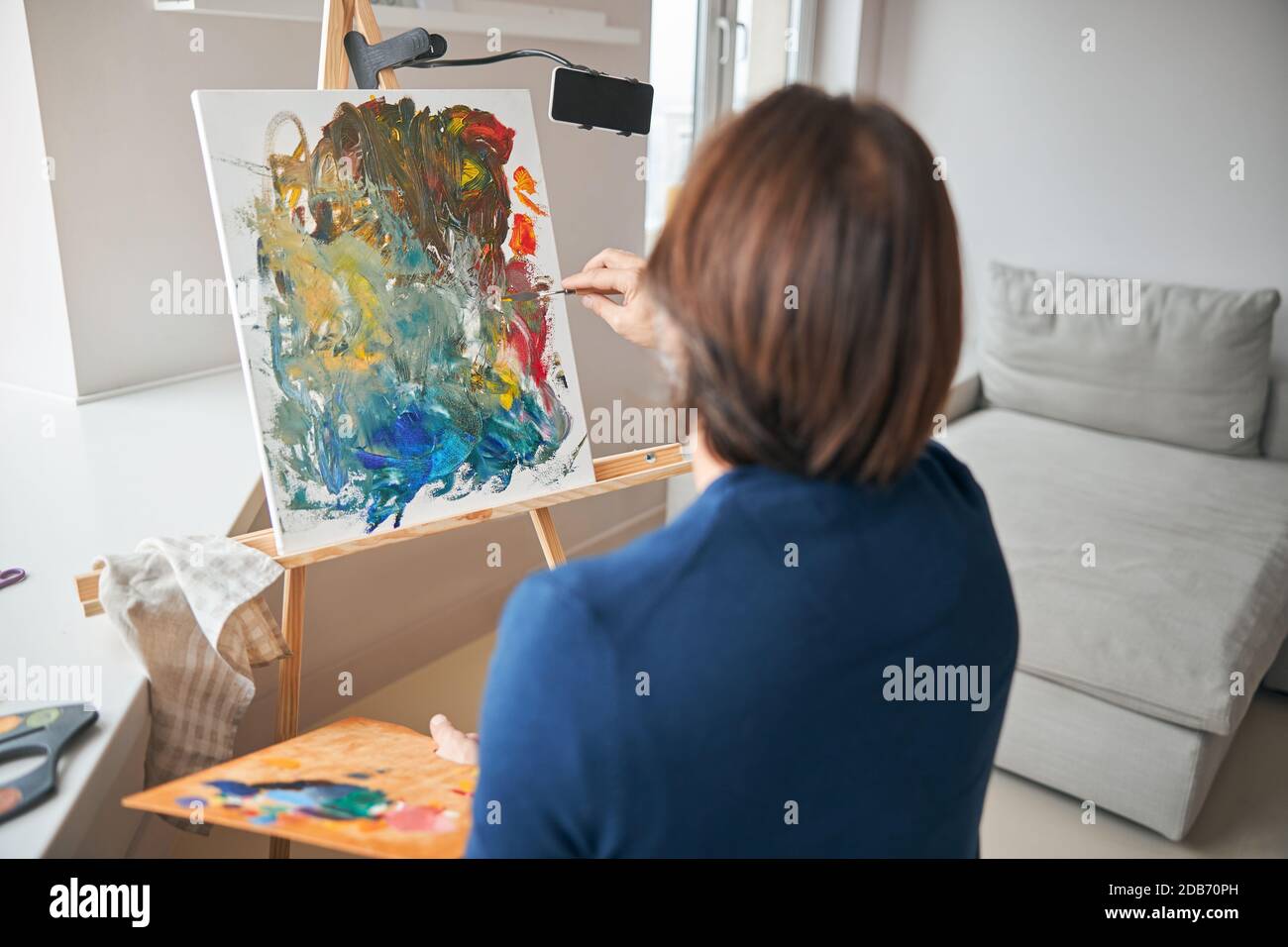 Back-view photo of focused artist creating a painting Stock Photo - Alamy