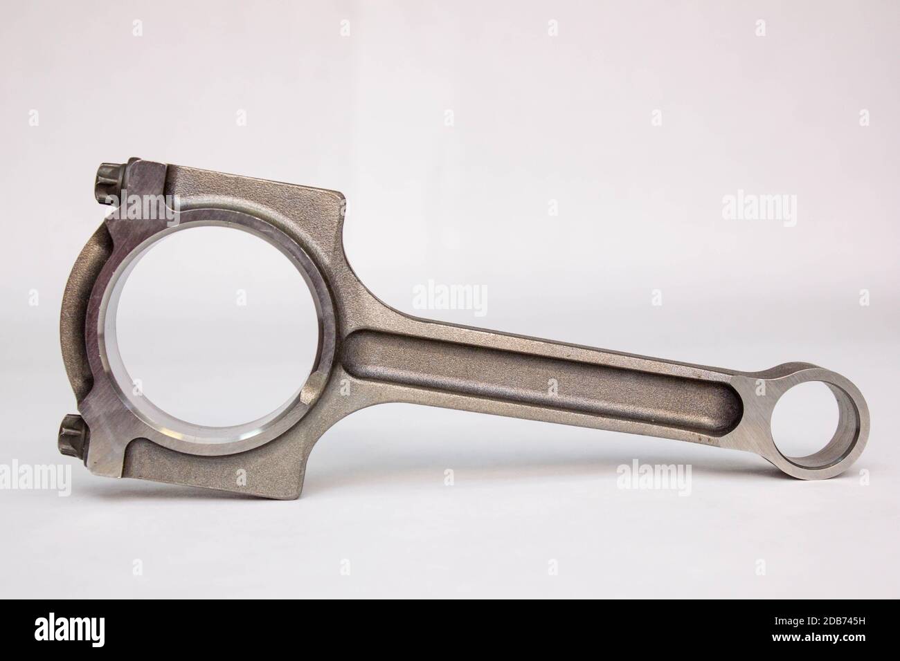 Connecting rod from a car engine isolated Stock Photo - Alamy