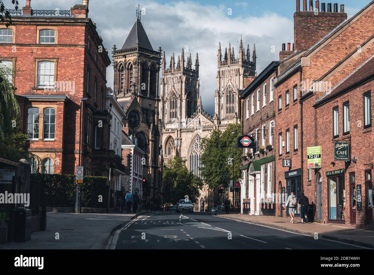 Street scene in York with a view of the York Cathedral and several ...