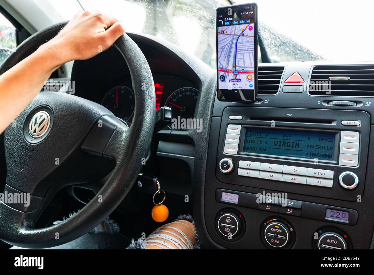 Using waze maps application on smartphone on car dashboard, Driver ...
