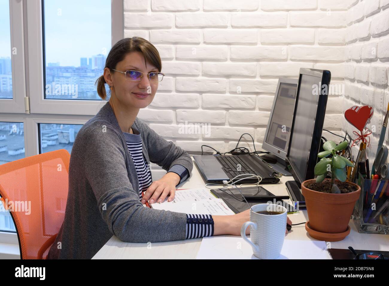 Happy girl working remotely at home looked into the frame Stock Photo ...
