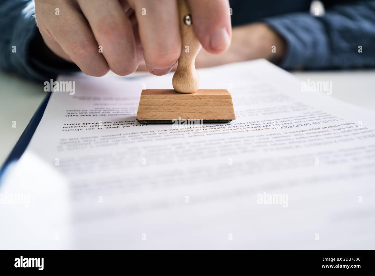 Close-up Of Person Hands Using Stamper On Document With The Text ...