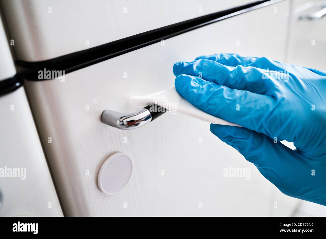 Man Wiping Cabinet Handle In The Kitchen With Sanitizer Against Virus ...
