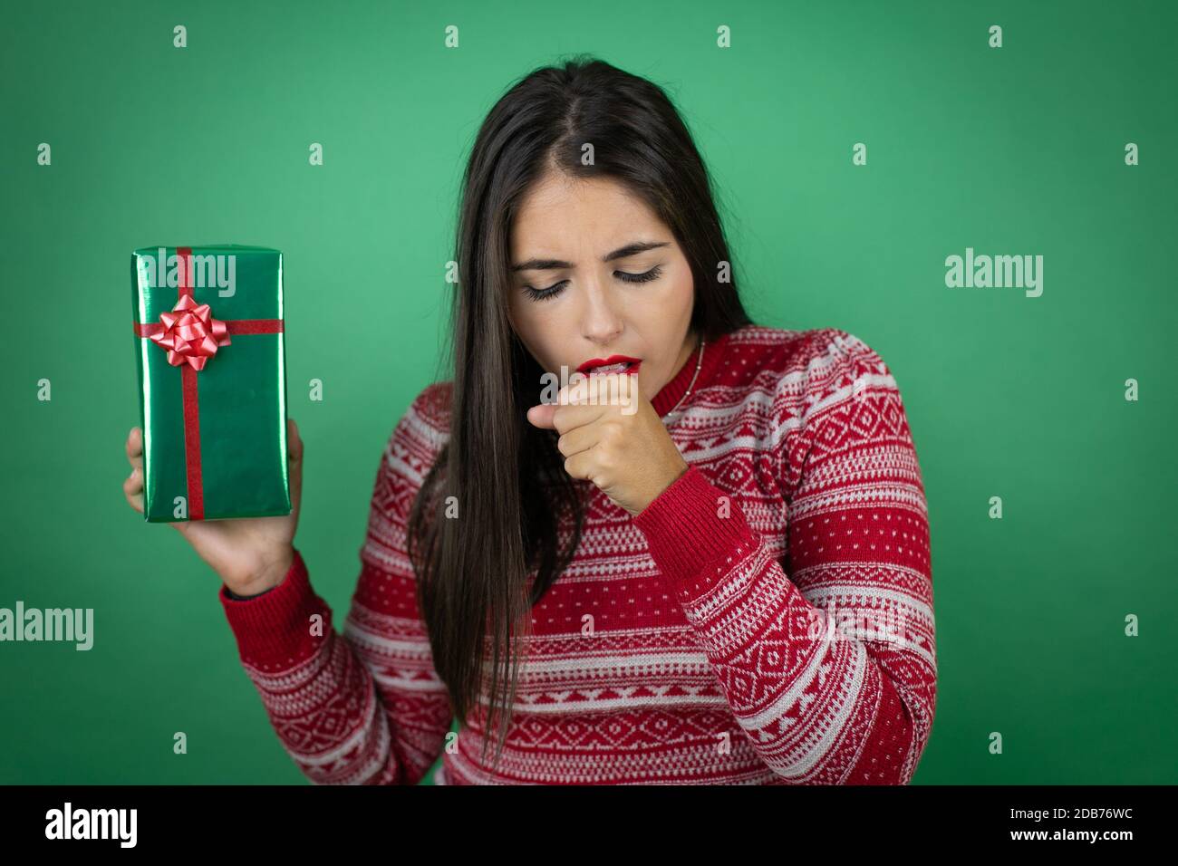Young beautiful girl holding gift over isolated white background with ...