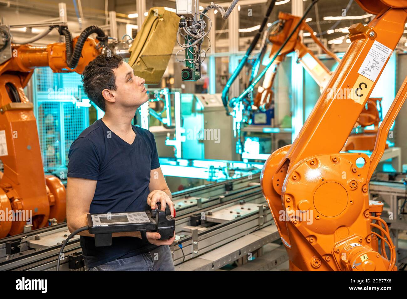 programming of robot arms for a new product by a production engineer ...